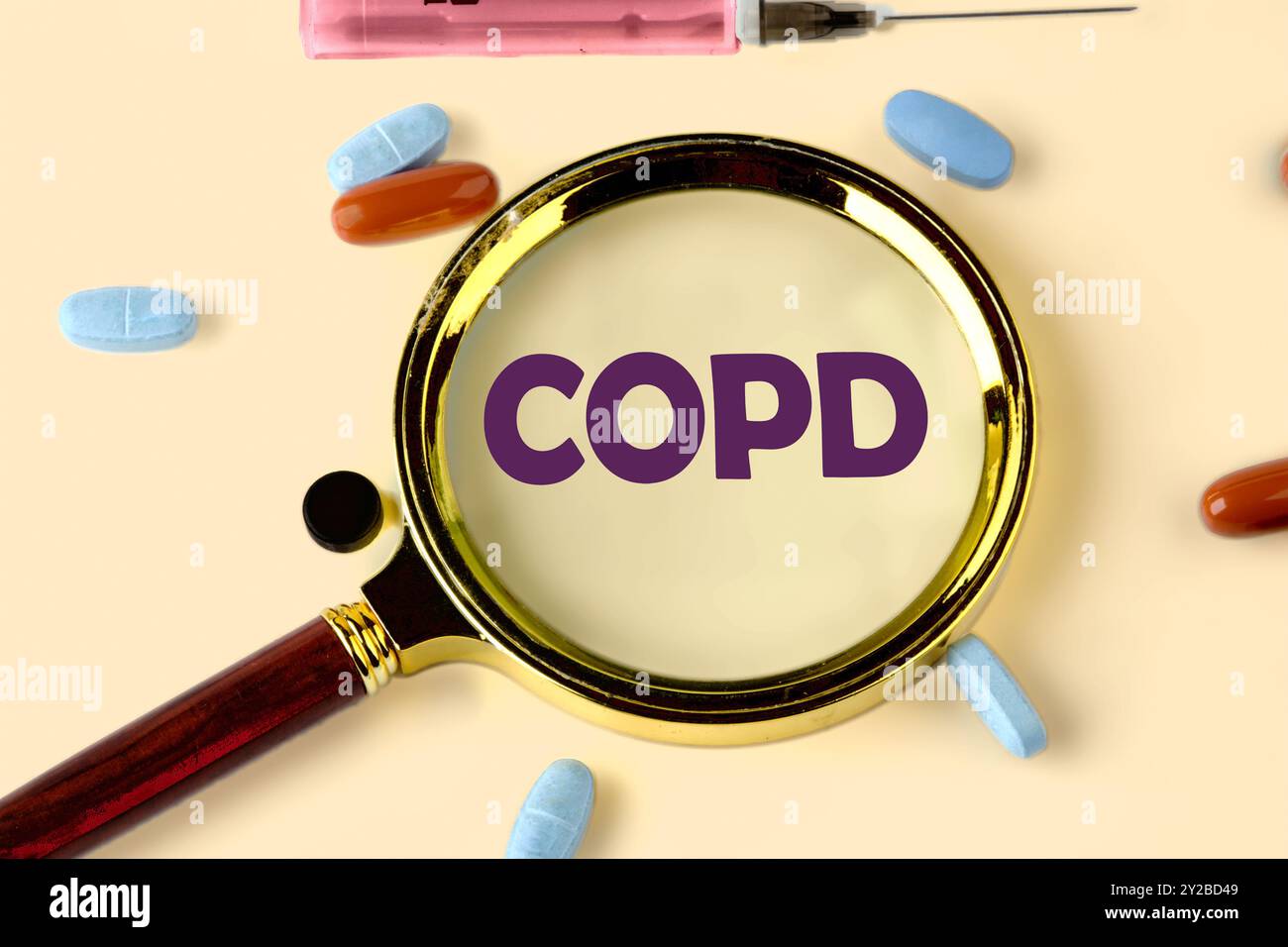 COPD word through a magnifying glass on a yellow background. The concept of a healthy lifestyle ...