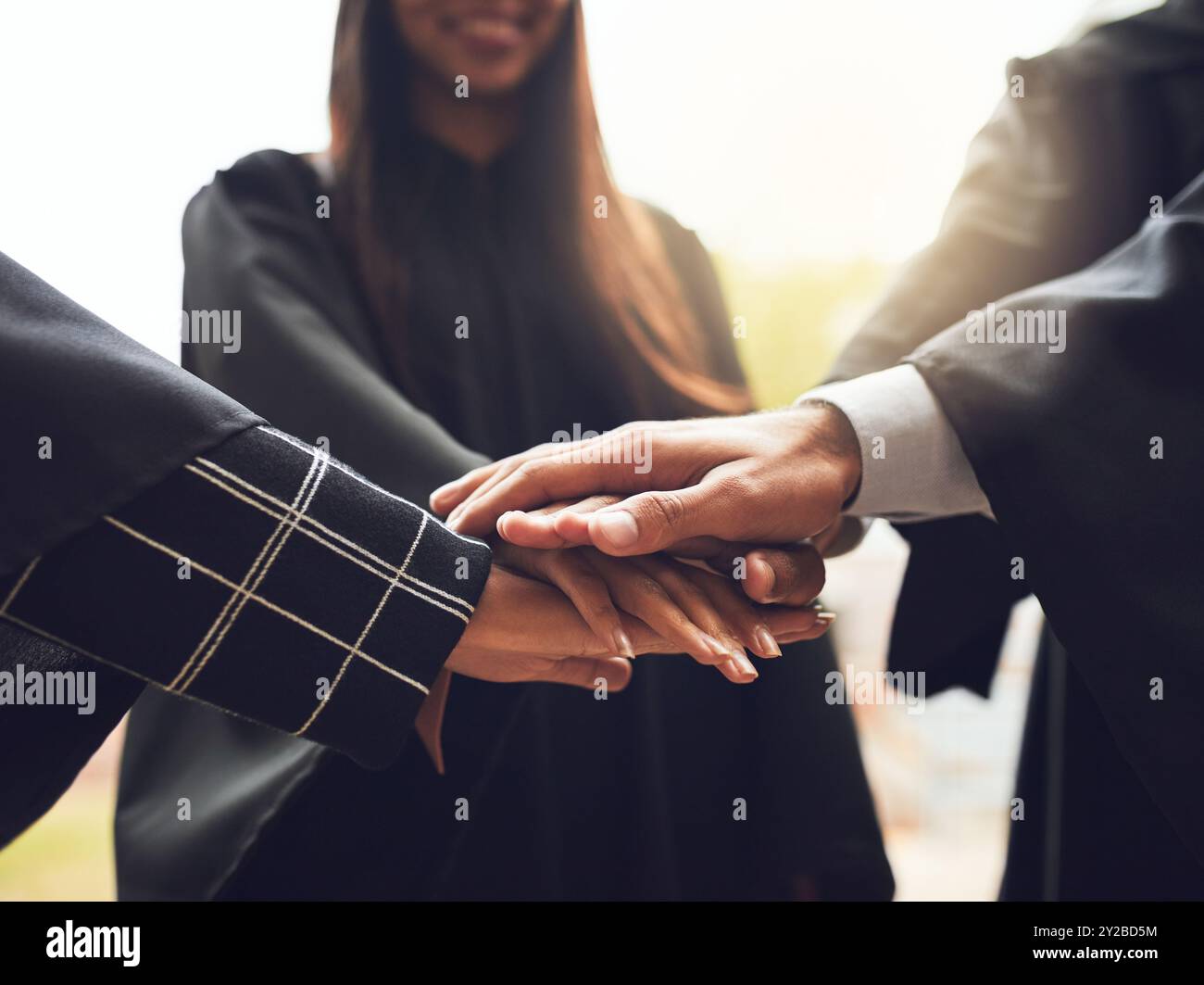 People, graduates and unity with hands together for graduation ...