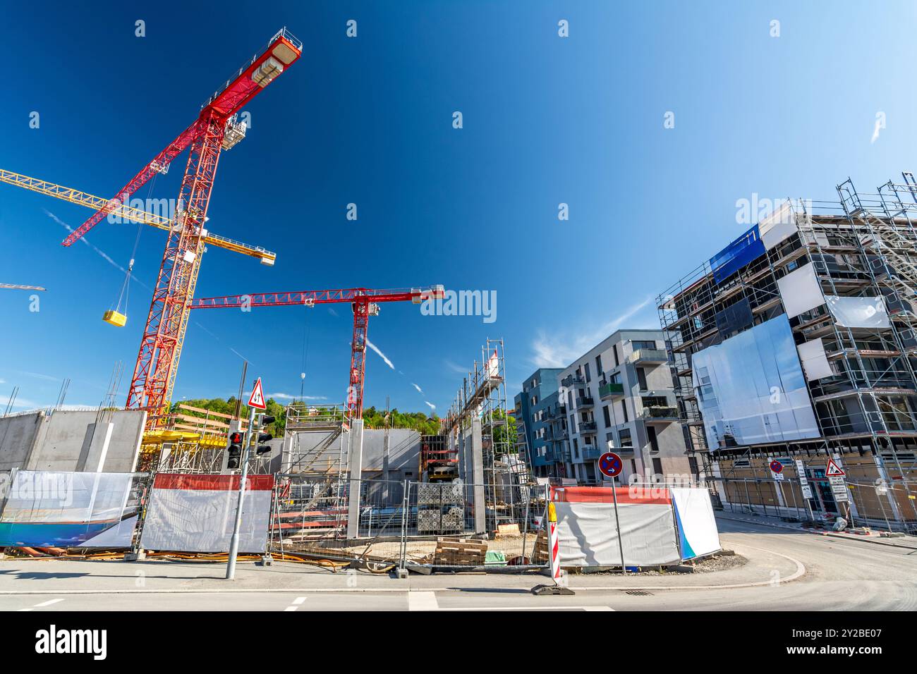 Large construction site with cranes, scaffolding and shell of ...
