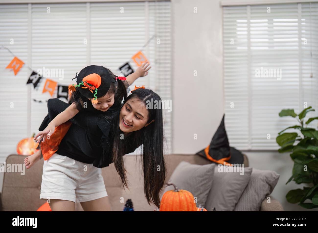 Mother and daughter enjoying Halloween playtime at home Stock Photo - Alamy