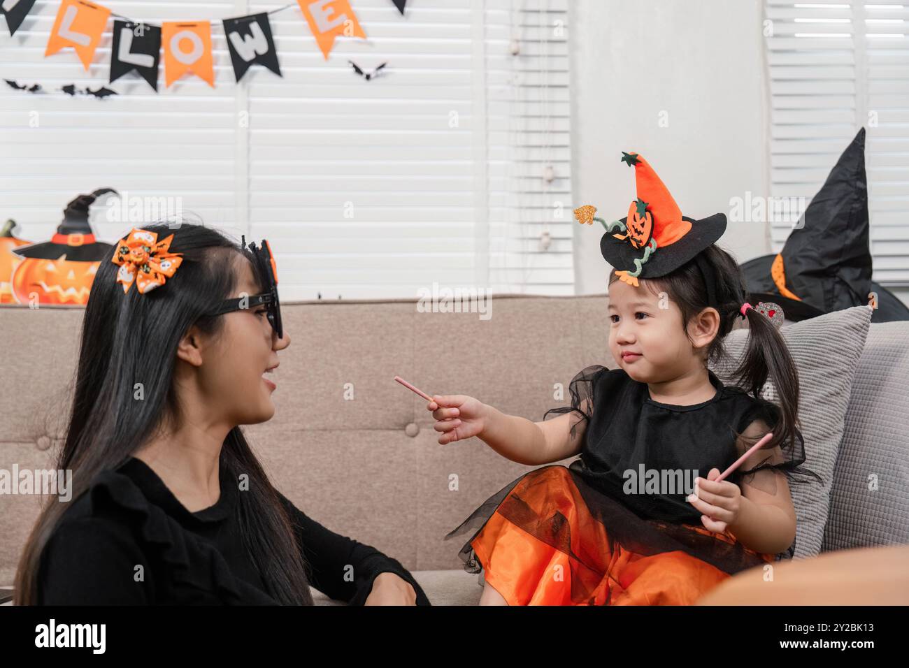 Mother and daughter sharing a playful Halloween interaction Stock Photo ...