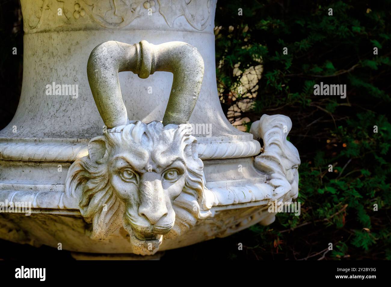 Lion head decorative stone structure on a plant pot, part of the ...