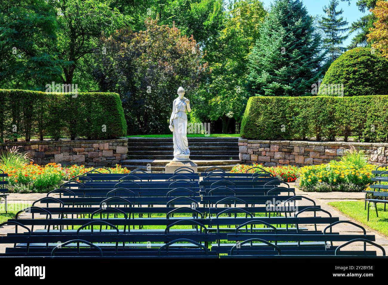Formal garden with a statue in the center, part of the grounds of ...