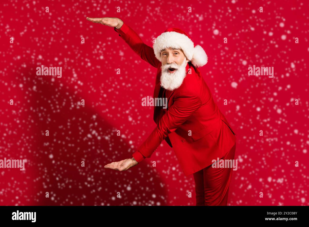 Photo of impressed white hair aged man hands measure wear santa cap red ...
