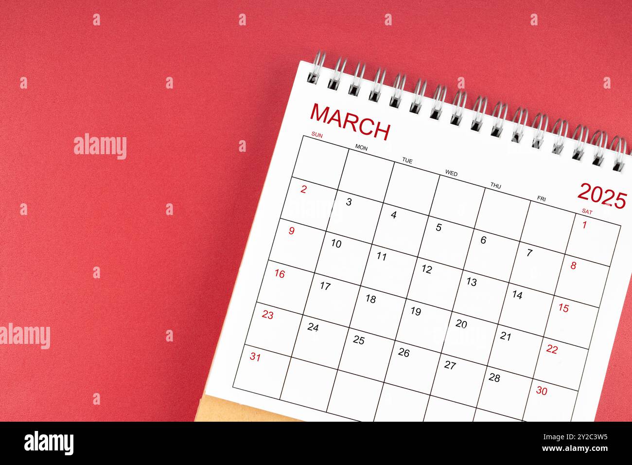 March 2025 desk calendar on red color background Stock Photo - Alamy