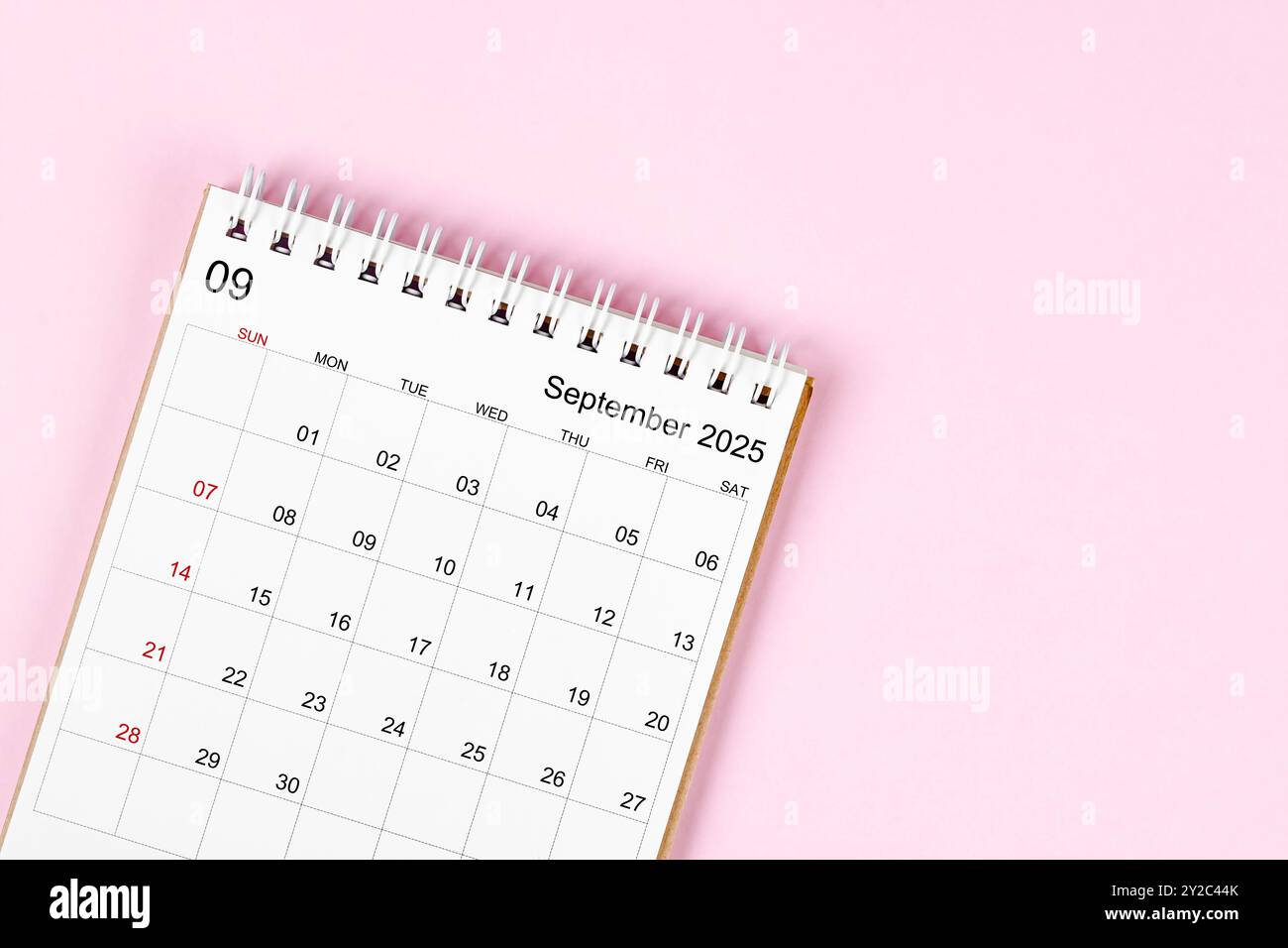 September 2025 desk calendar on pink color background, Position with ...