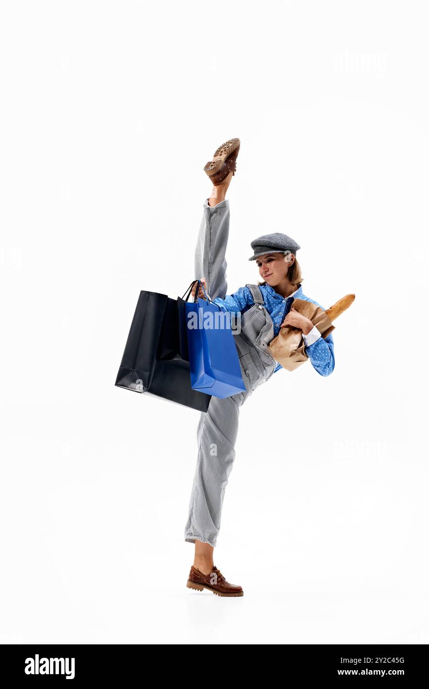 Gracefully lifting leg high, woman in dynamic ballet pose while ...