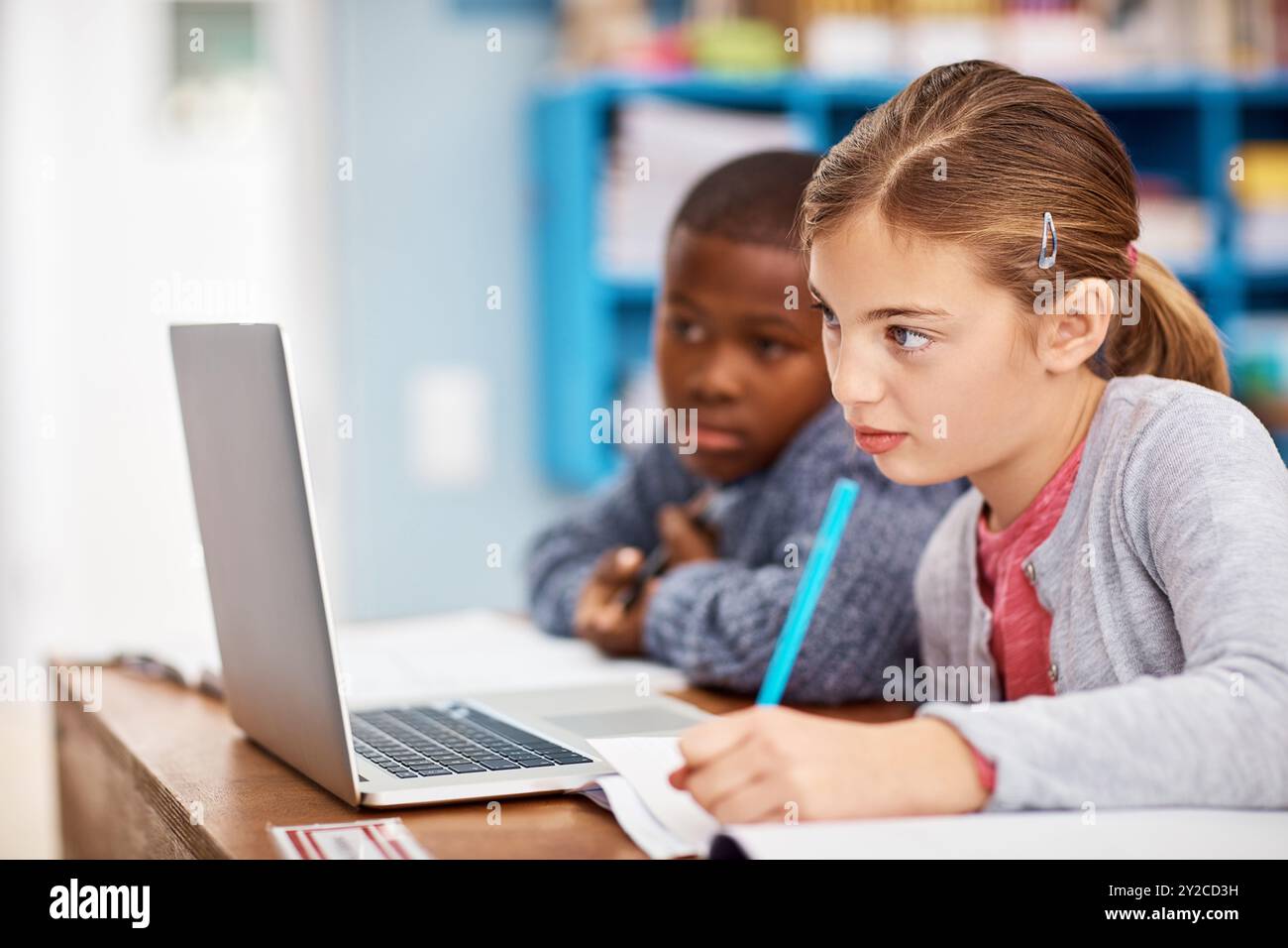 Laptop, notes and school kids in classroom together with project for ...