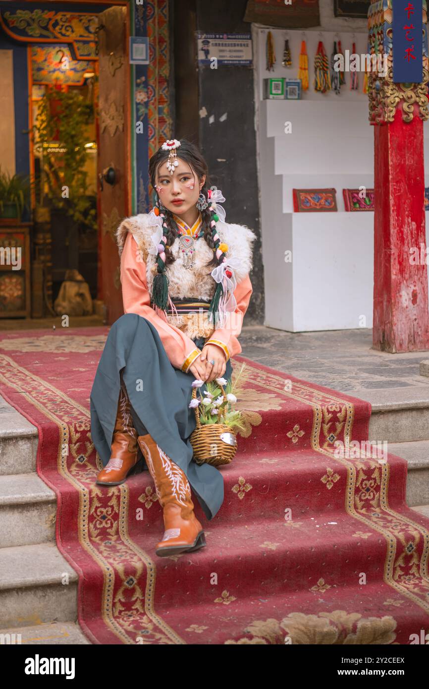 Lhasa, Tibet, July 3, 2022: Lady posing at ancient temple door in a ...