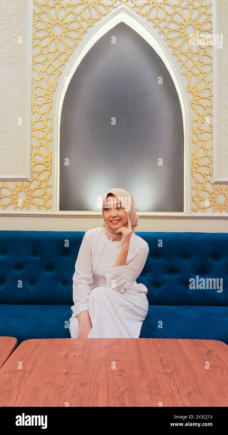 beautiful asian woman crooked to the right, cheerful, holding her chin ...