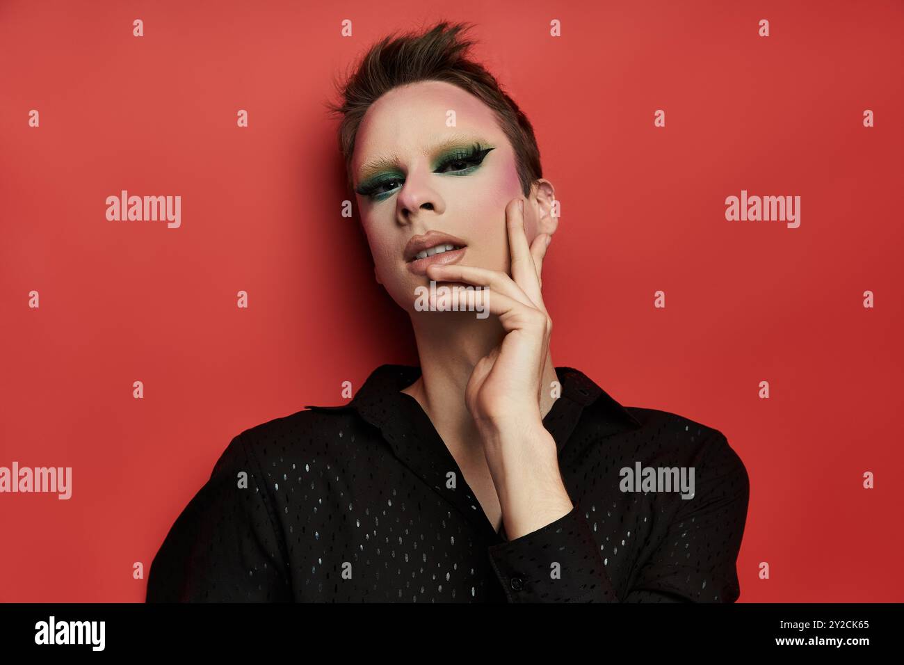 A young drag artist exudes confidence and flair in striking attire and ...