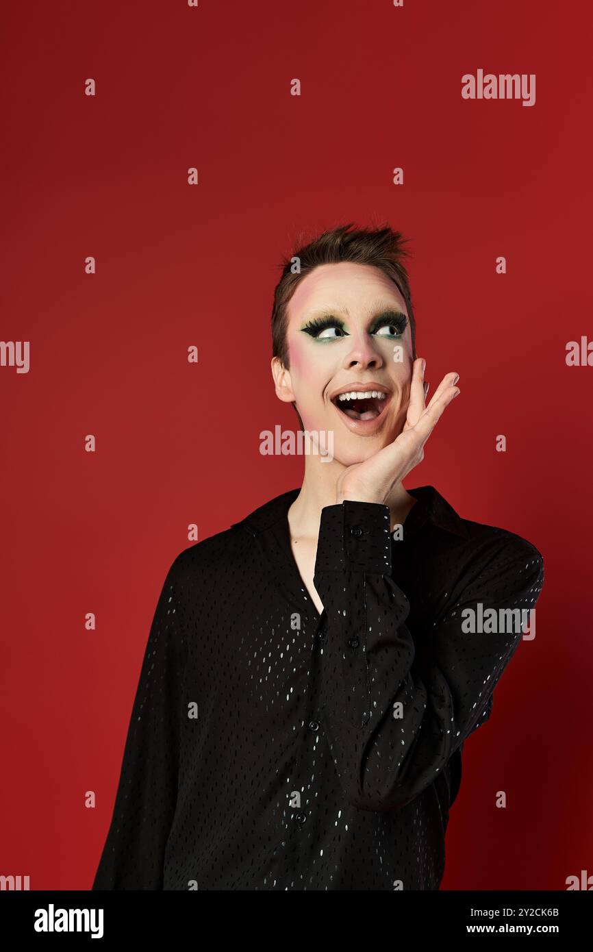 A young drag performer showcases stylish attire with a playful ...