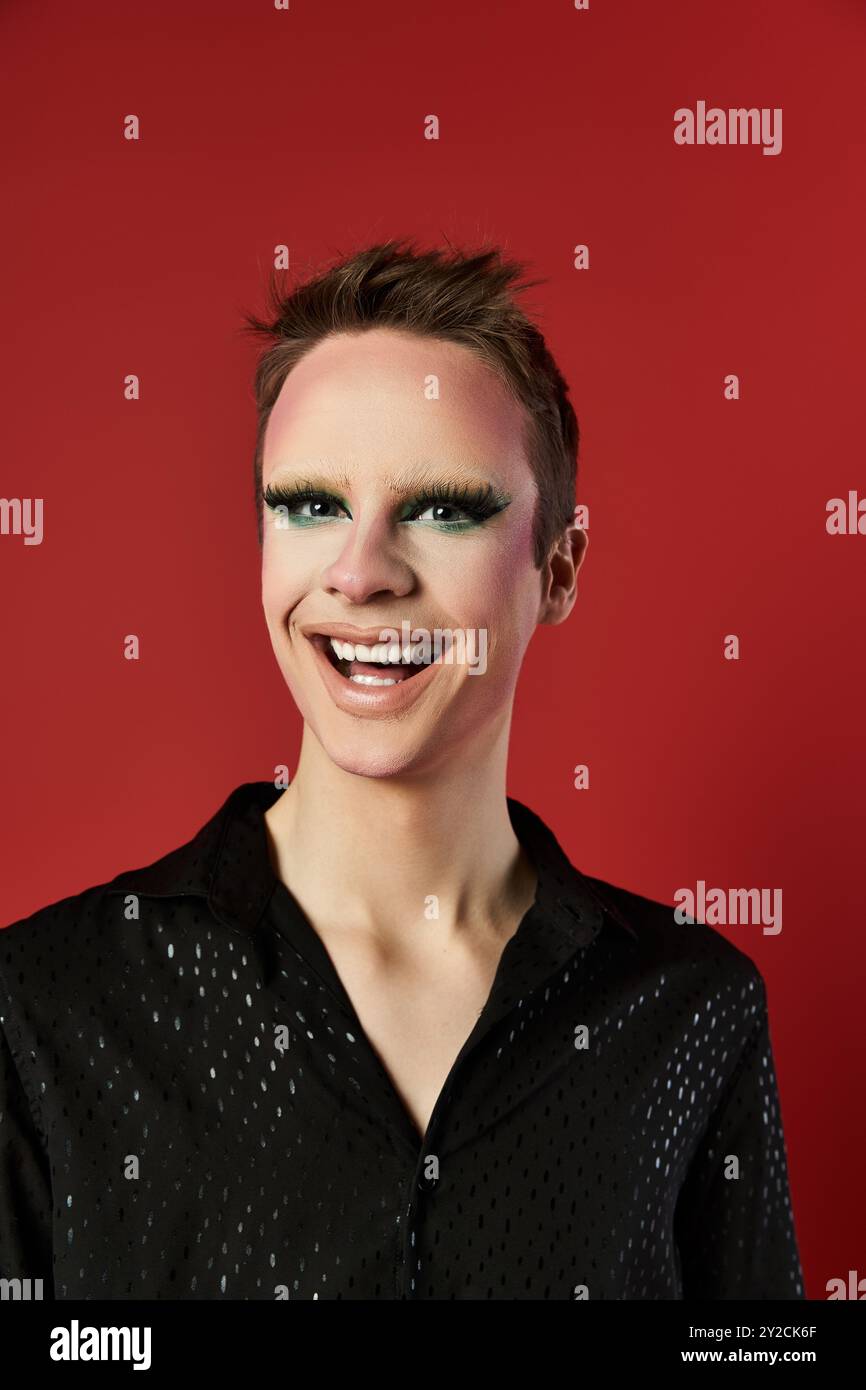 A young drag artist poses joyfully in striking fashion attire Stock ...