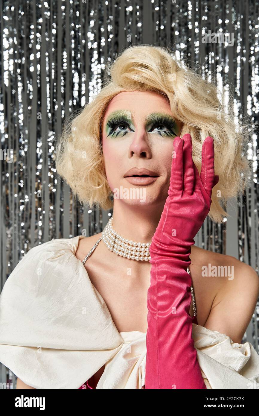 A vibrant drag artist showcases dazzling attire and energetic ...