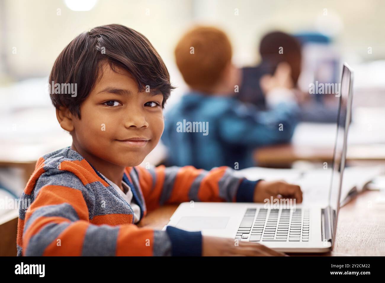 Laptop, kids and portrait of boy in classroom for study project with ...