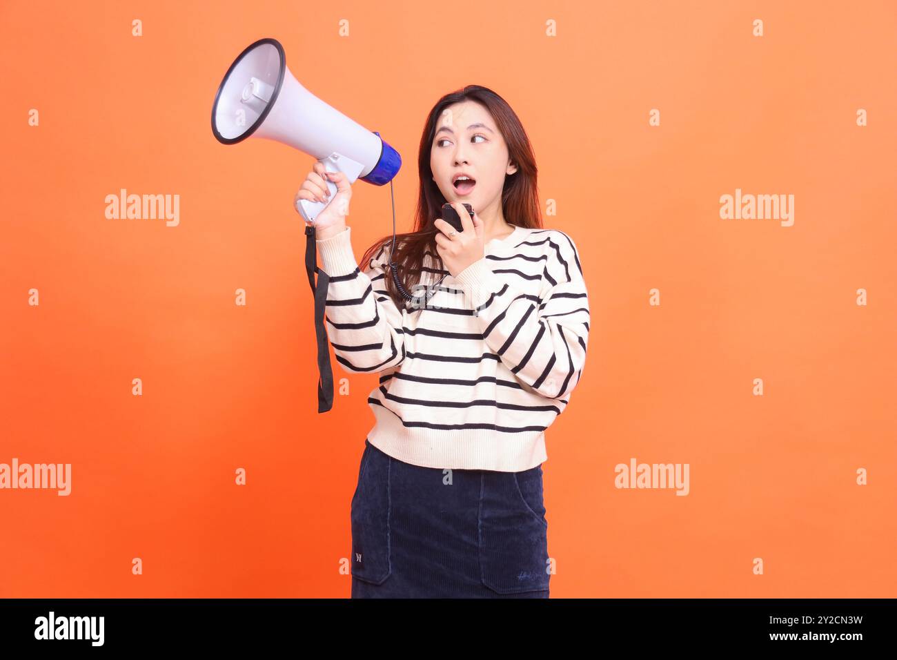 an indonesia woman shouting expression using a candid mic stands ...
