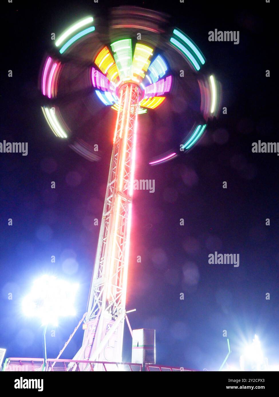 A modern fairground ride at night with neon lights Stock Photo - Alamy