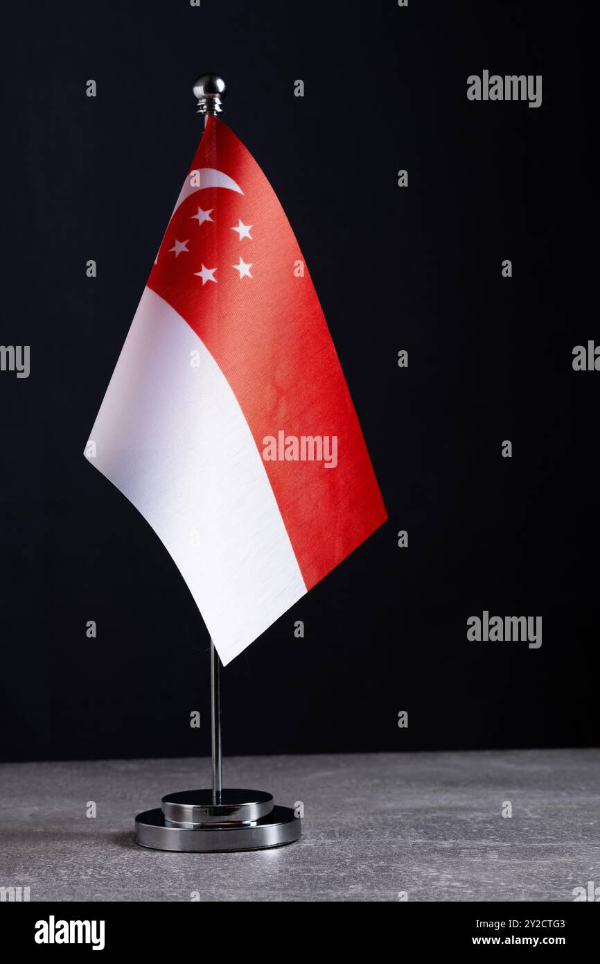 National flag Singapore on metal flagpole on black background Stock ...