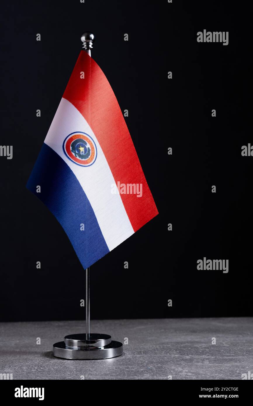 National Flag of Paraguay on stand against black background Stock Photo ...