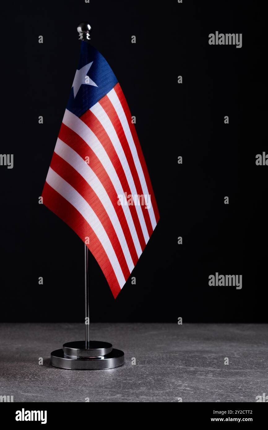National flag United States with one star on stand on black background ...