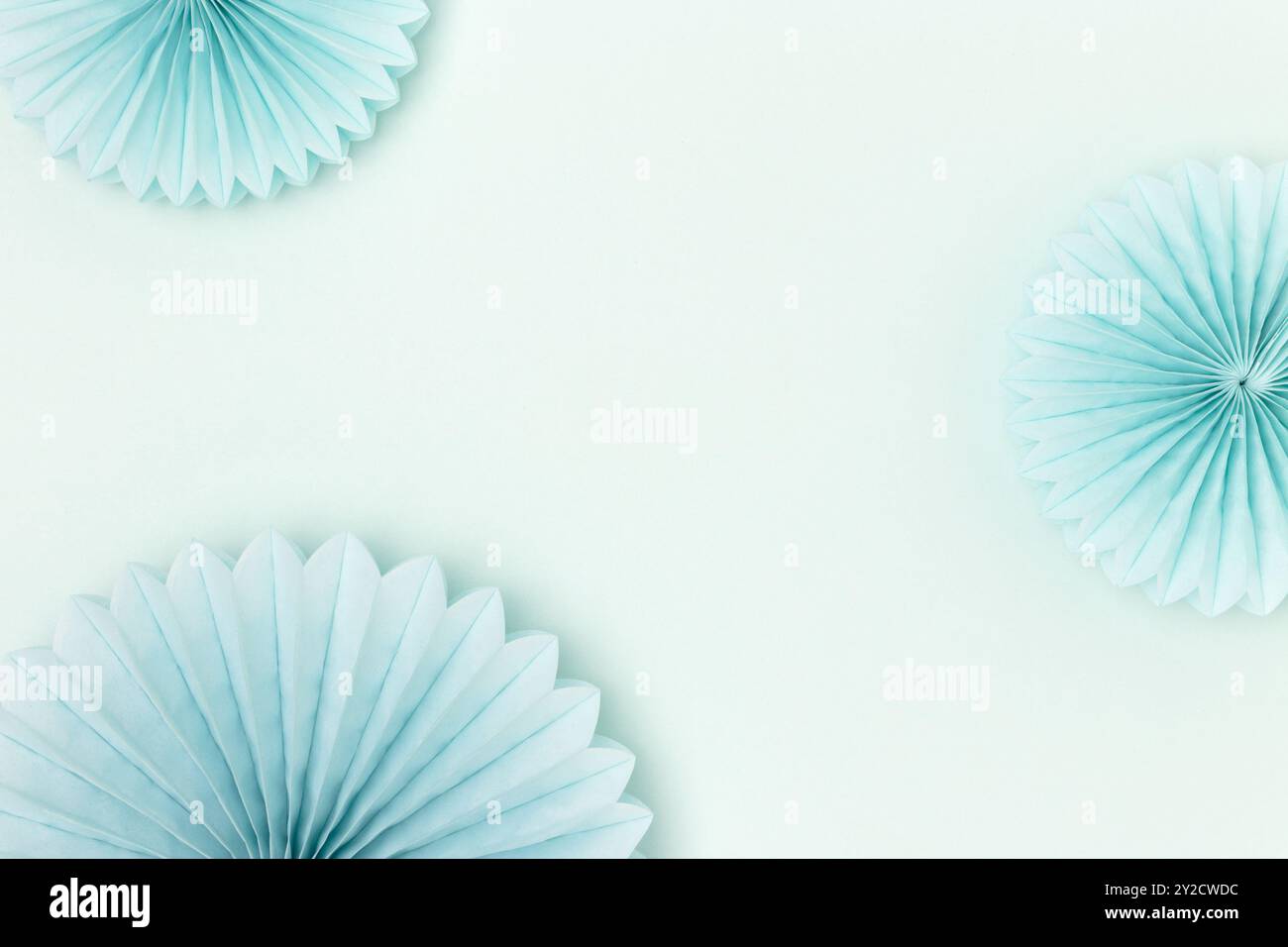 Tissue paper fans scattered on a blue background. Creative border frame ...