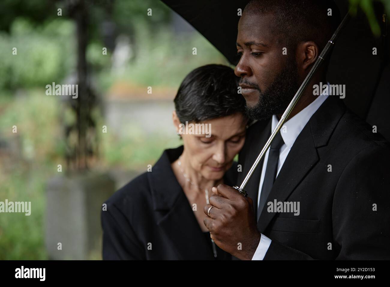 Side view of sorrowful Black man comforting grieving senior woman ...