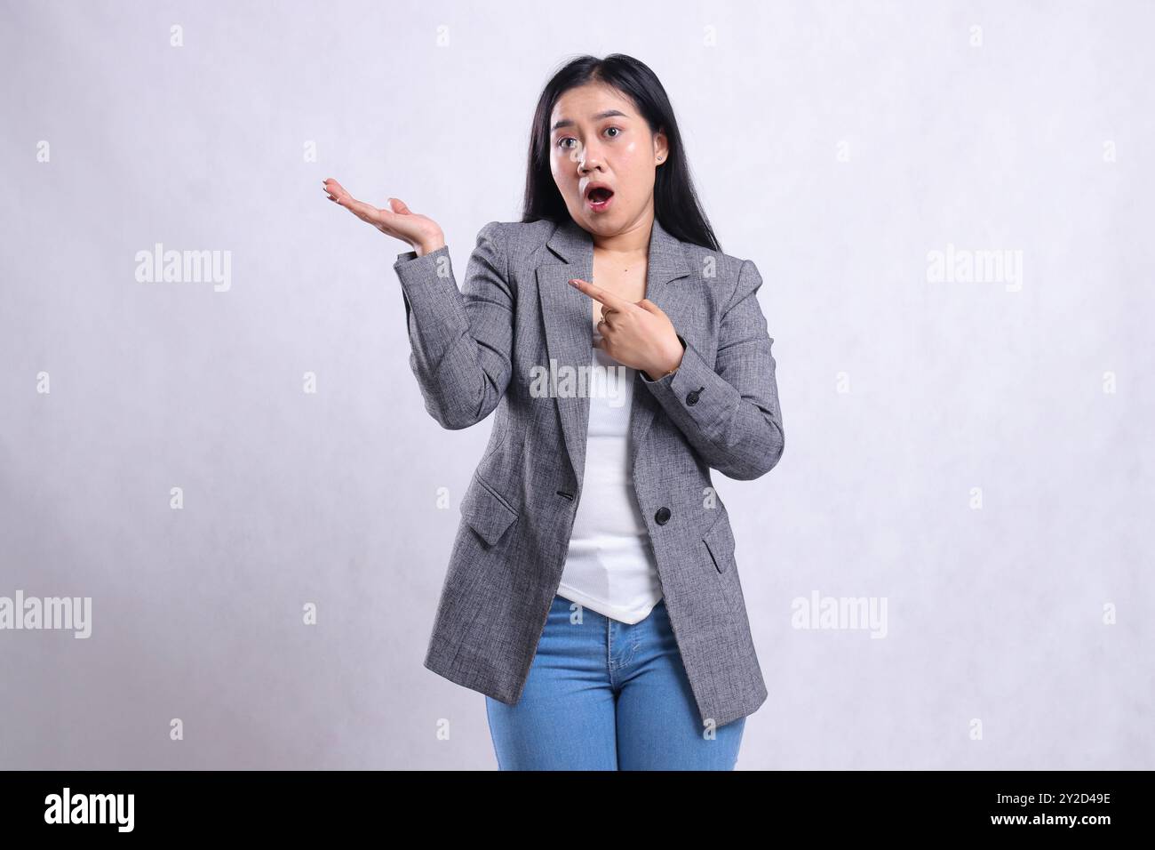 expression of young beautiful ladies surprised hand pointing ...