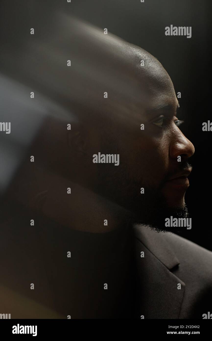 Vertical profile shot of adult African American man in formal suit ...