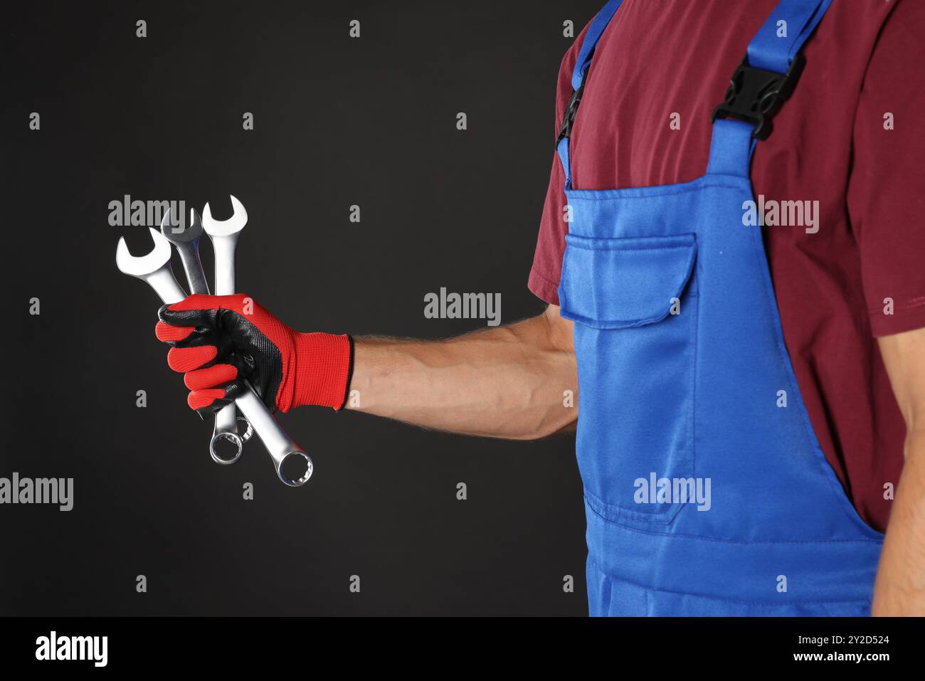 Auto mechanic with wrenches on black background, closeup Stock Photo ...
