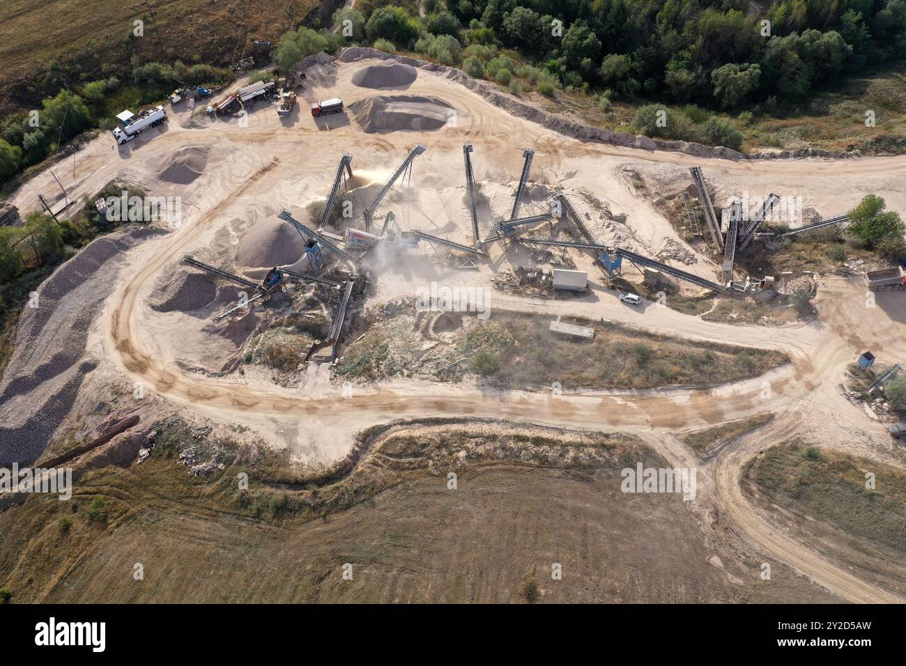 Aerial view of stone quarry conveyor belt system in operation, stone ...