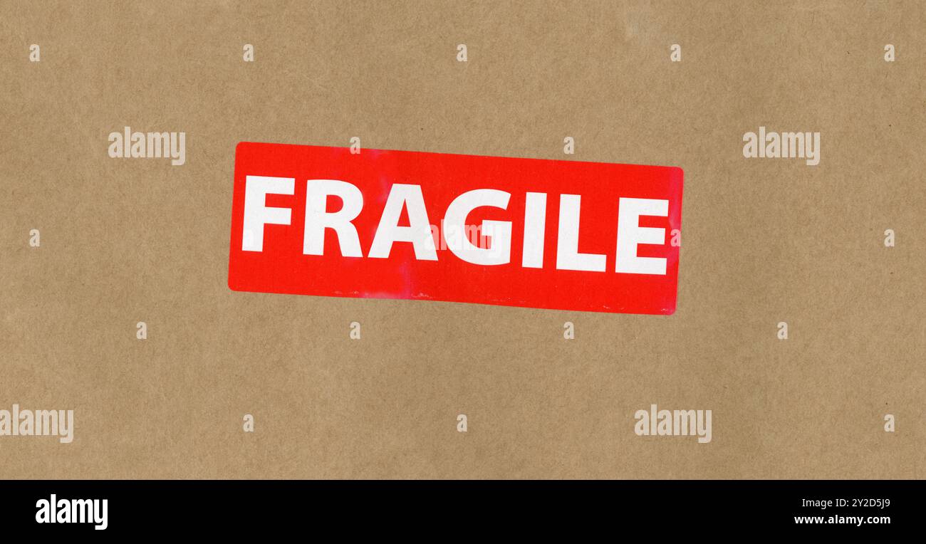 red fragile sign on brown paper background Stock Photo - Alamy