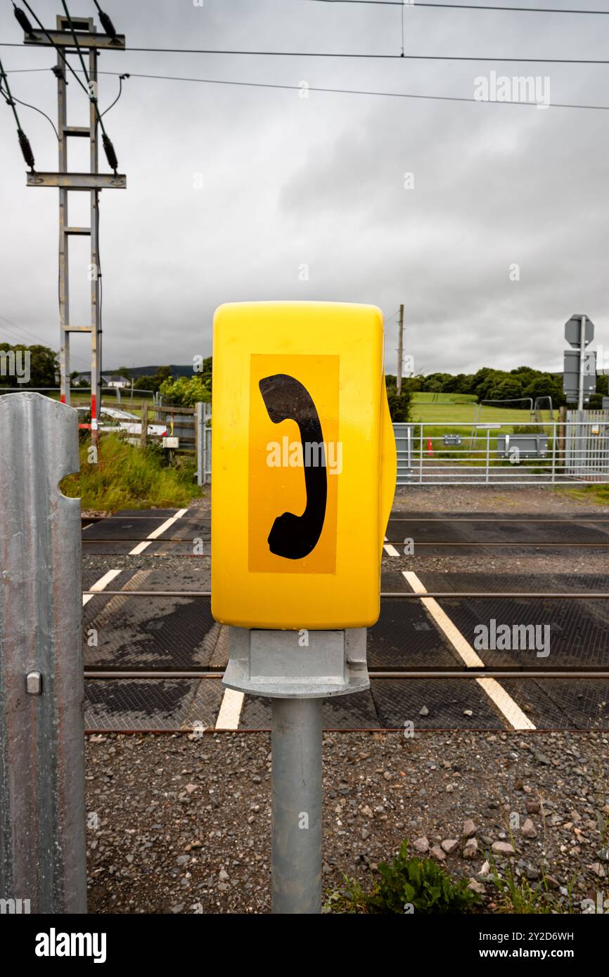 Portrait orientation of a close-up of a yellow phone call point at an ...