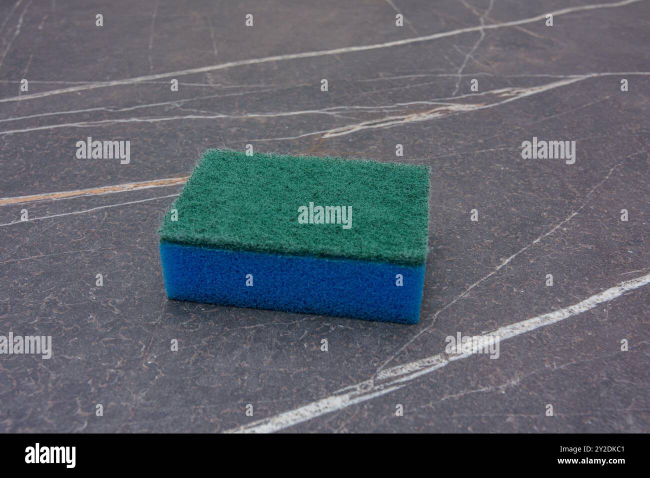 A blue cleaning sponge on a marble top Stock Photo - Alamy