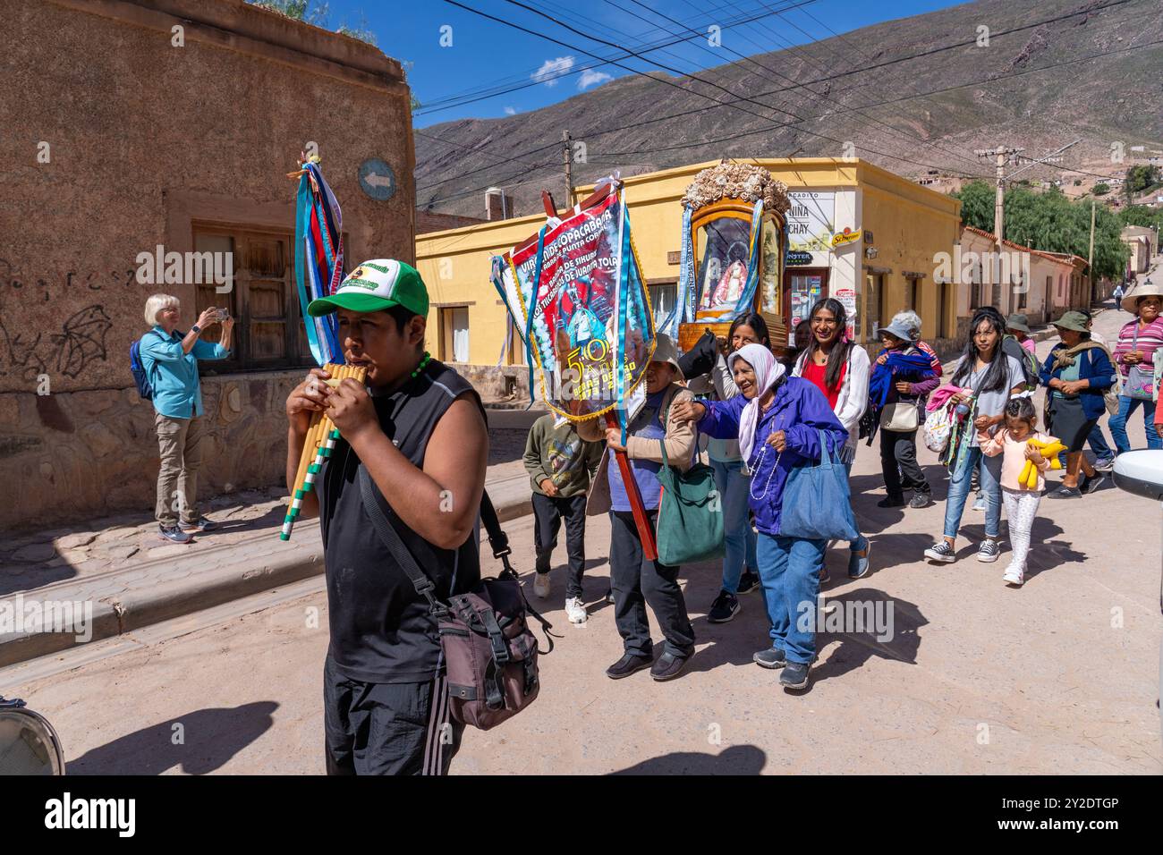 An indigenous man playing the siku panpipes leads a religious ...
