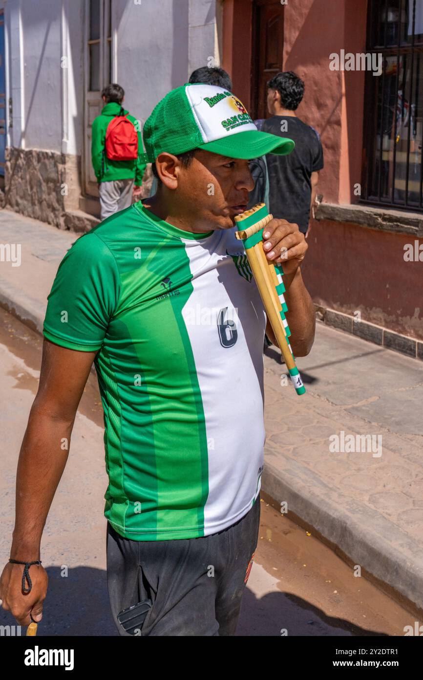 An indigenous man plays the siku panpipes plays for a religious ...