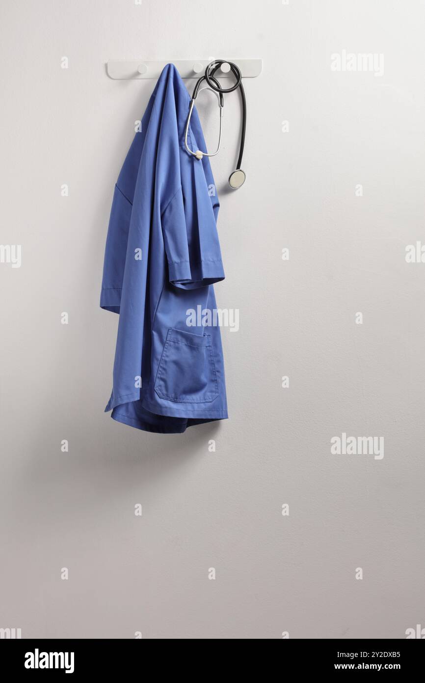 Medical blue uniform and a stethoscope on a hanger isolated on white ...