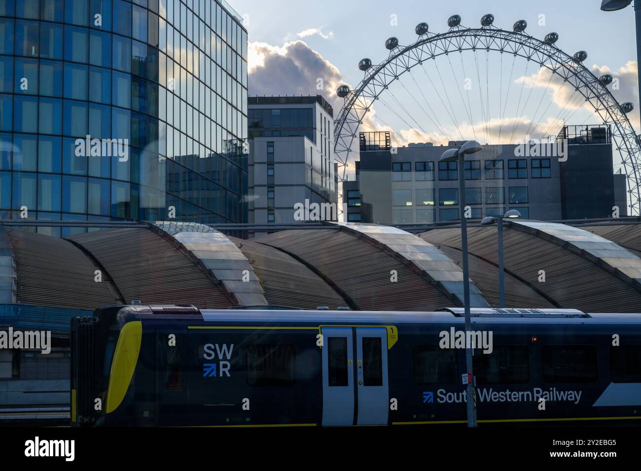 The London Eye big wheel reflected in the window of a train. Waterloo ...