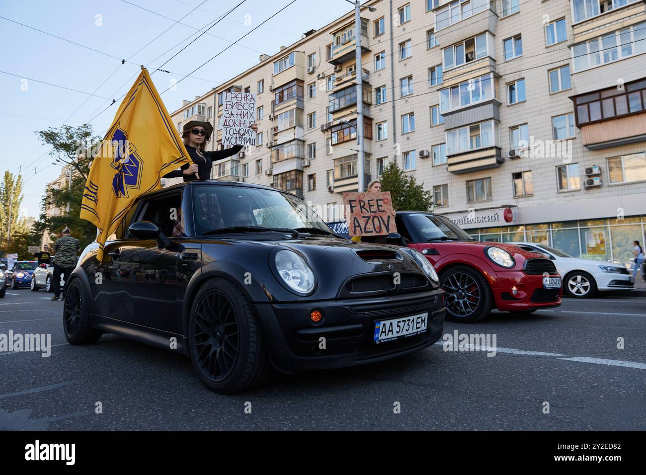 Ukrainian activists ride in car with flag of Azov brigade and banners ...