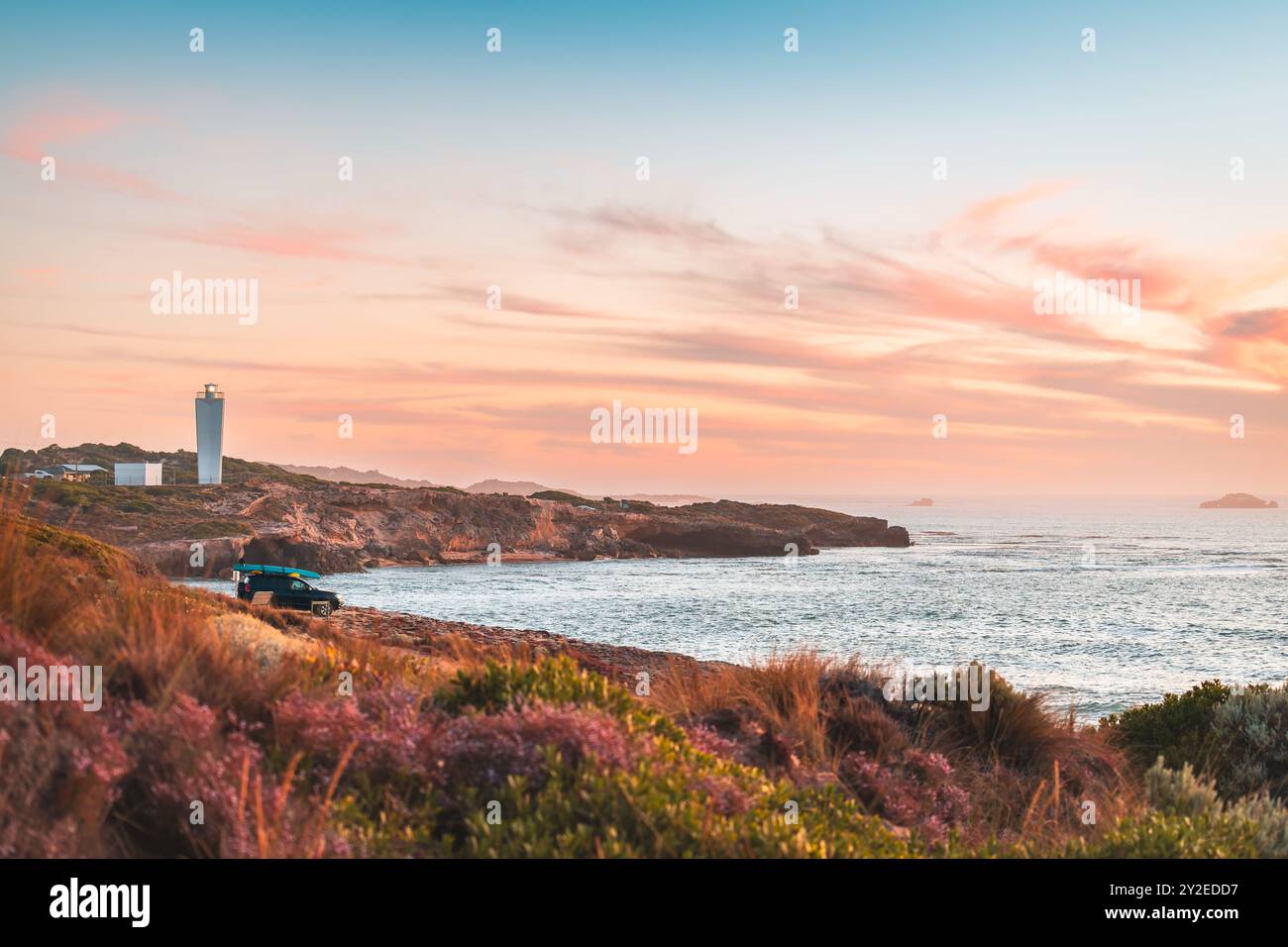 4WD car parked on rocky beach in Robe with driver enjoying the scenic ...