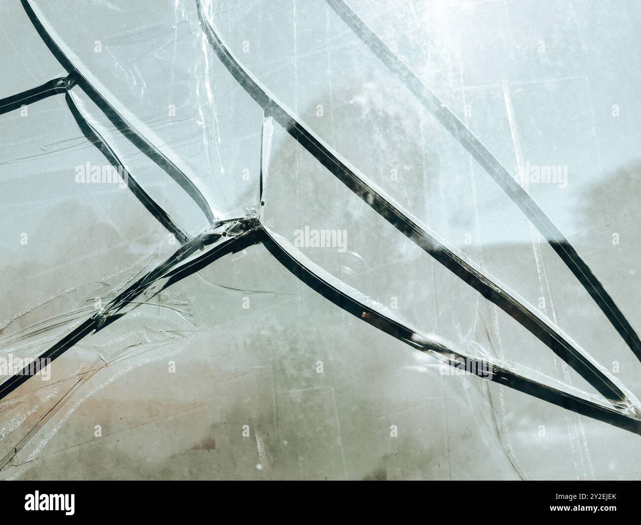 Abstract background with deep cracks on glass, worn window surface ...