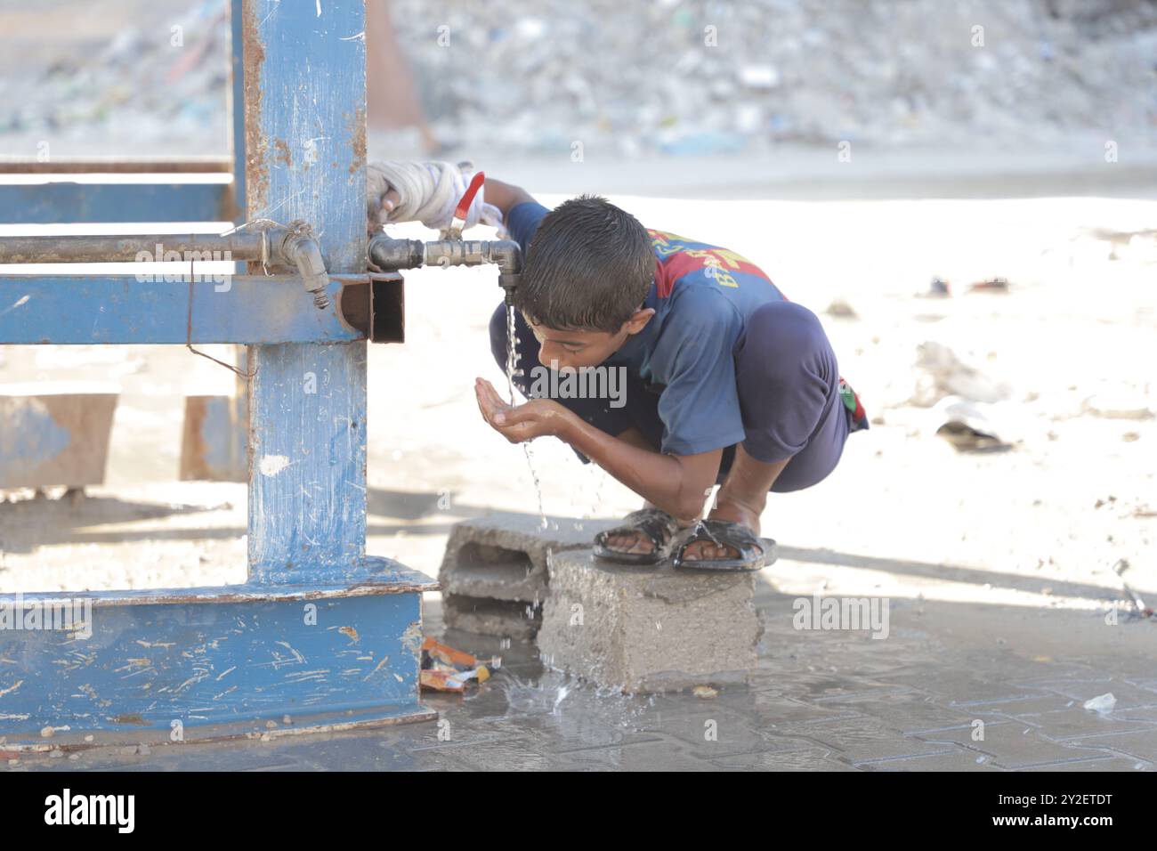 Gaza. 9th Sep, 2024. A boy drinks tap water at the Jabalia refugee camp ...
