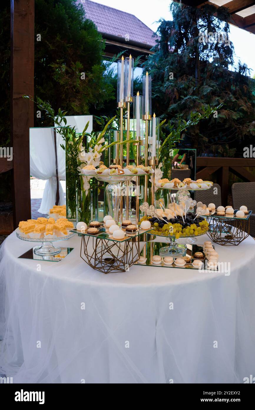Elegant Outdoor Dessert Table Display with Candles and Treats Stock Photo - Alamy