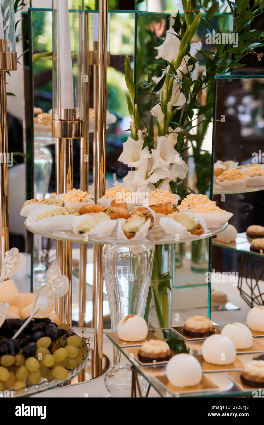Elegant Dessert Display with Floral Decor and Assorted Pastries at ...