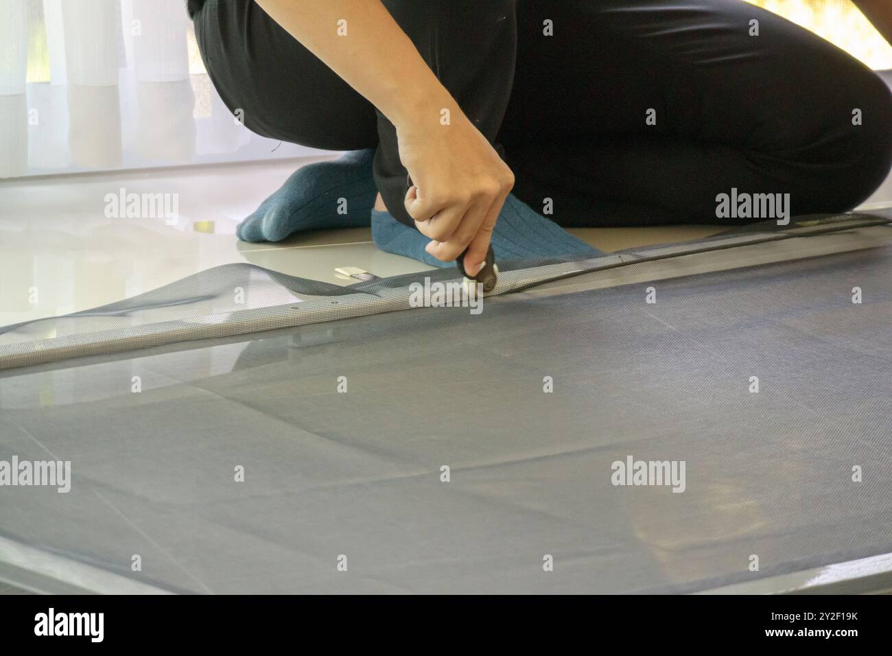 man install mosquito net wire screen on house window protection against ...