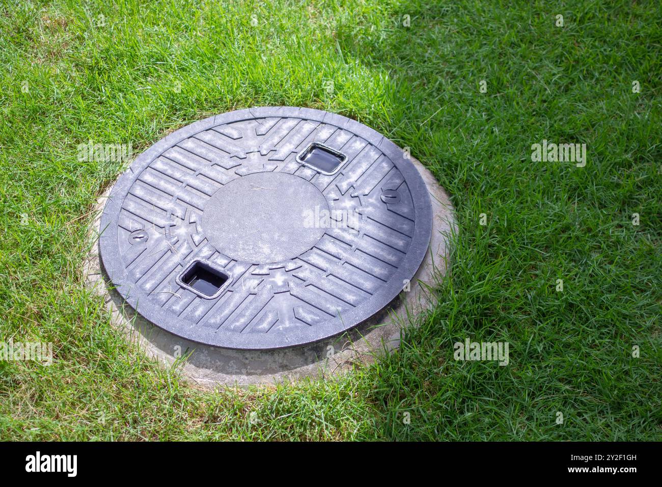 Septic tank cover underground waste treatment system Stock Photo - Alamy