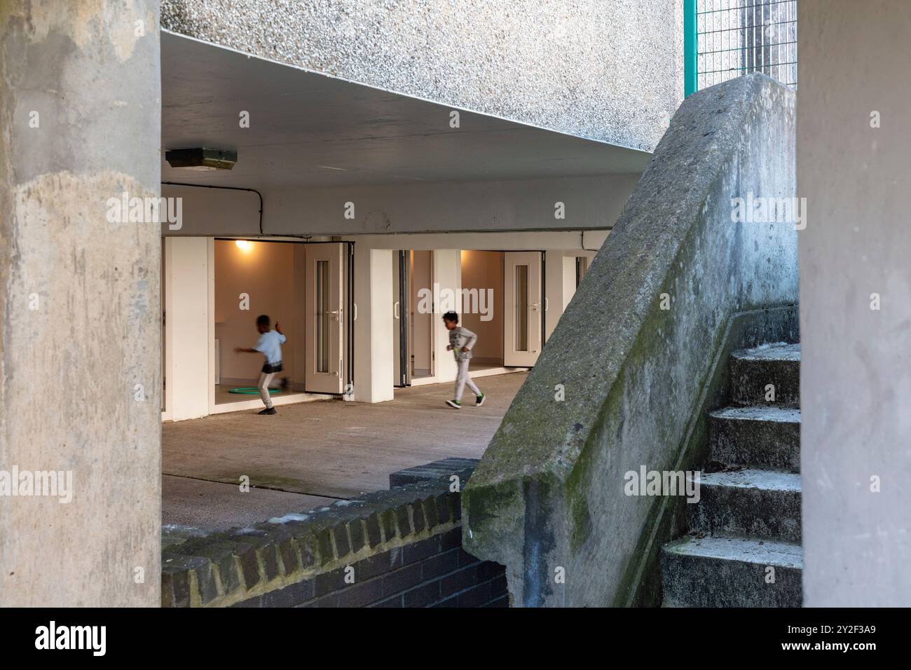 Children running down one of the undercrofts, showing the concrete ...