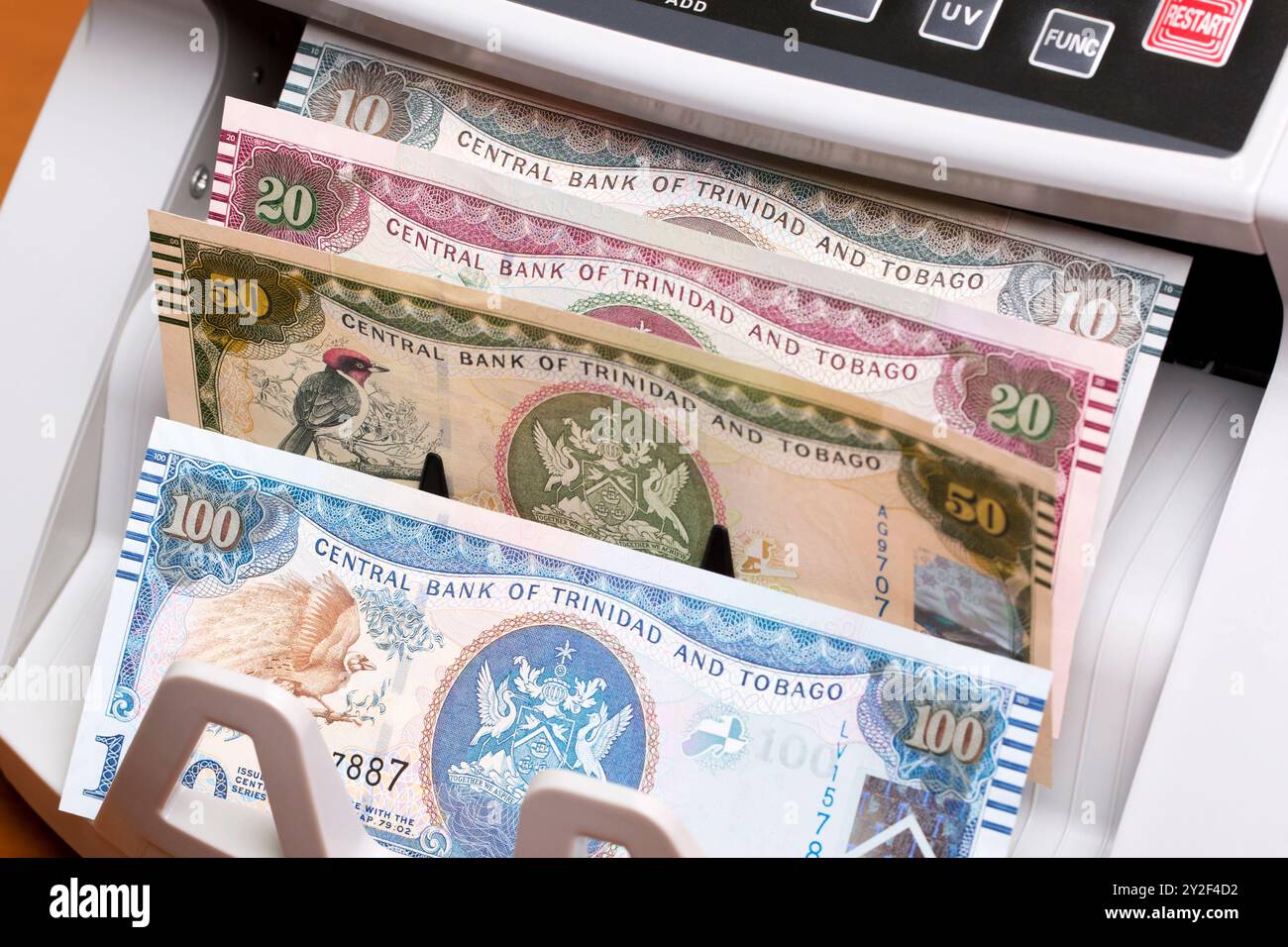 Trinidad and Tobago money - dollar in the counting machine Stock Photo ...