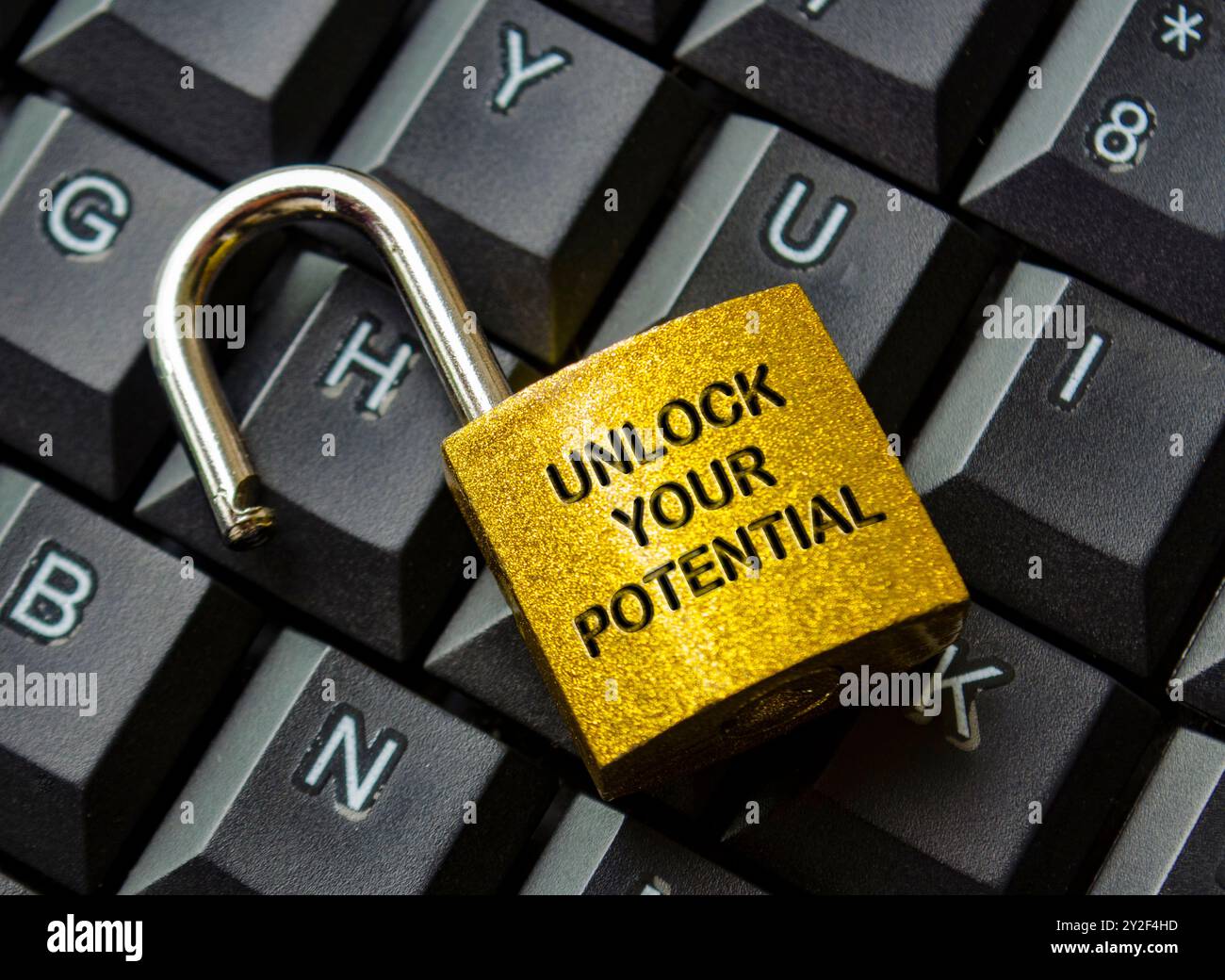 Unlock Your Potential text engraved on golden padlock with keyboard ...