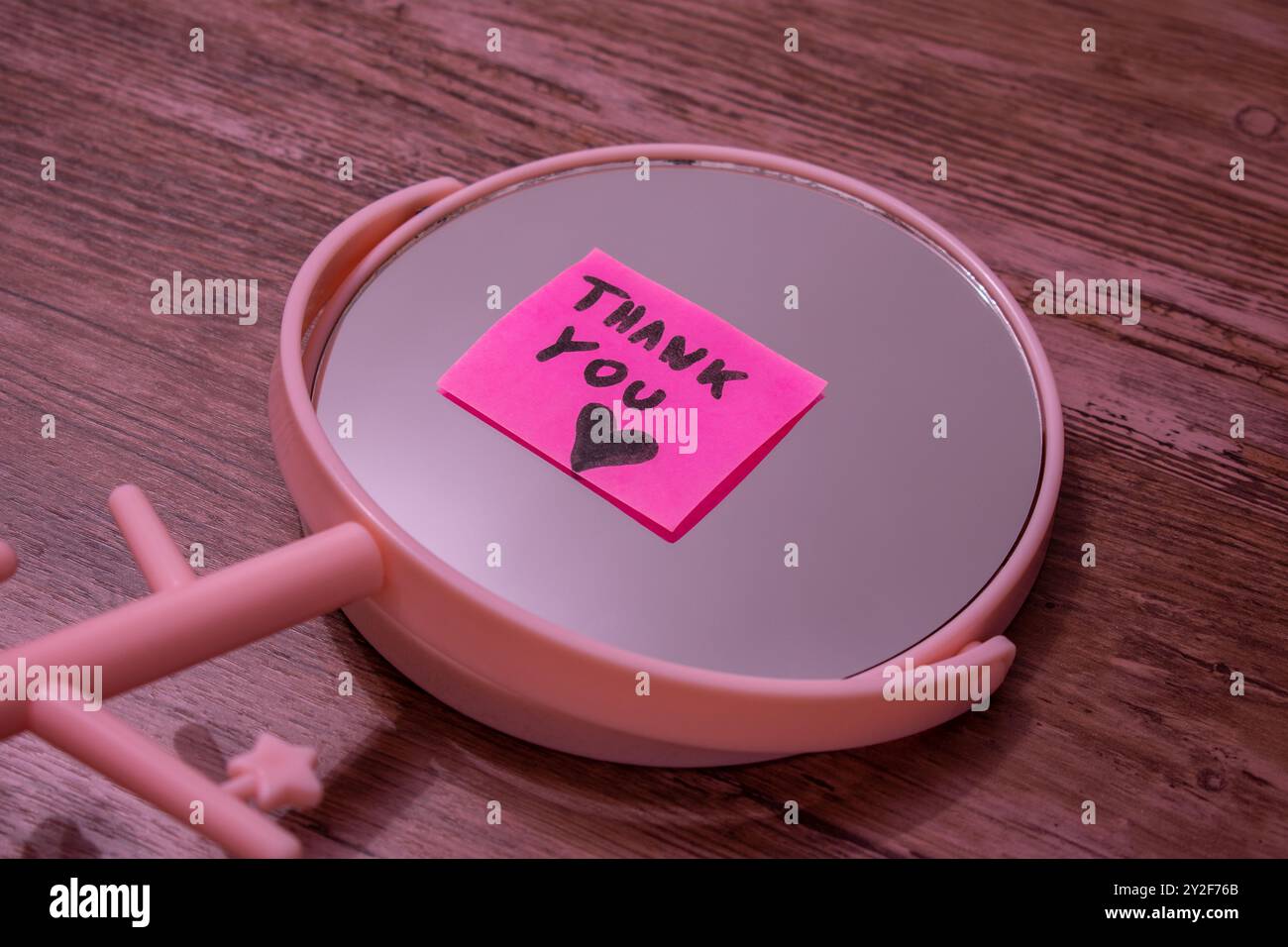 Sticky note with the words Thank you written neatly in bold, black ink ...