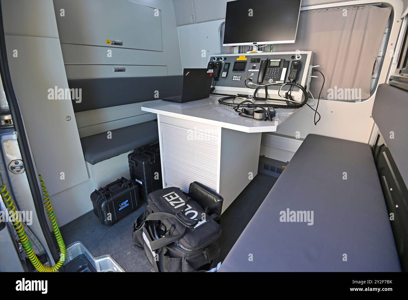 View through the open sliding door of a police patrol car into the ...